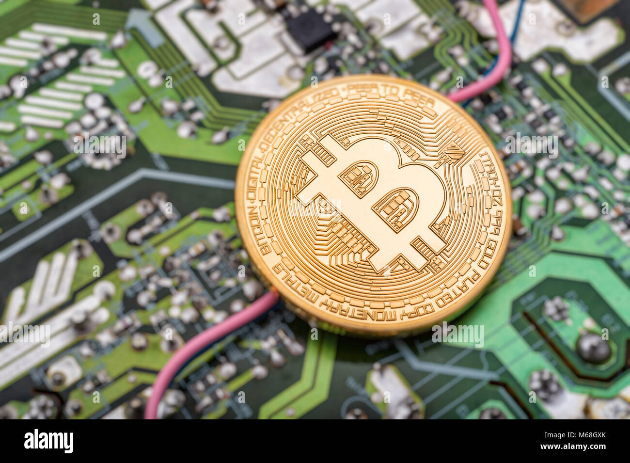 Circuit board and cryptocurrency Bitcoin coin Stock Photo - Alamy
