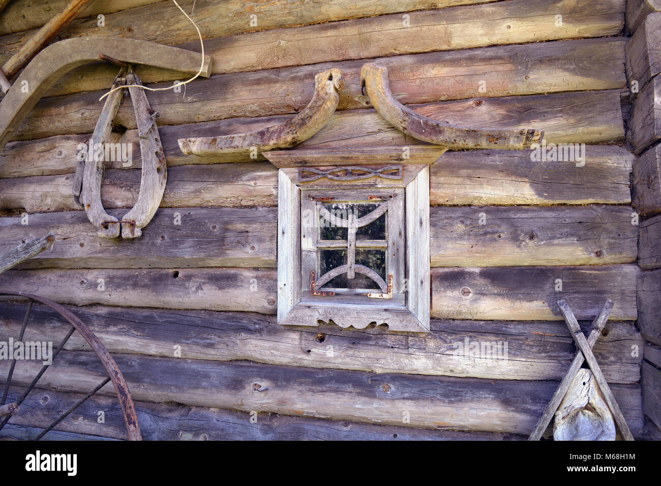 Ancient wooden barn wall with old agriculture tools and window Stock ...