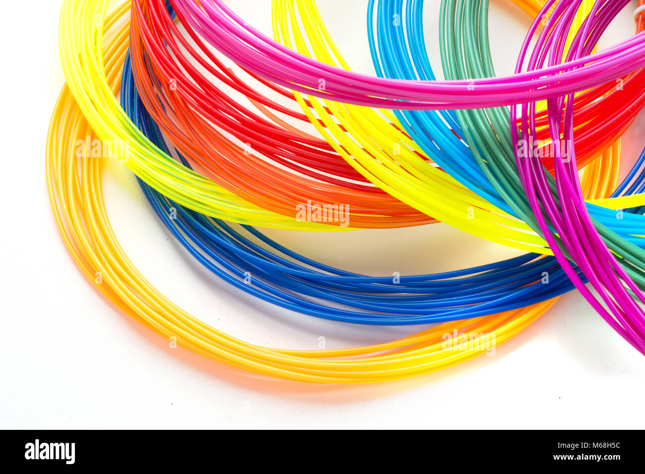Colorful rainbow plastic filaments with for 3D pen laying on white ...