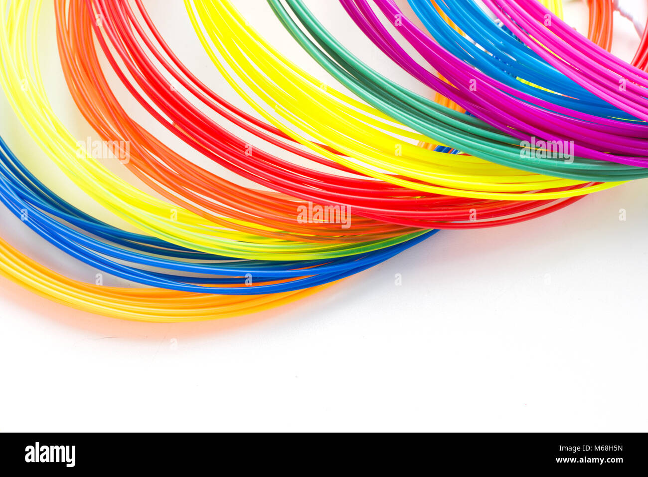 Colorful rainbow plastic filaments with for 3D pen laying on white ...