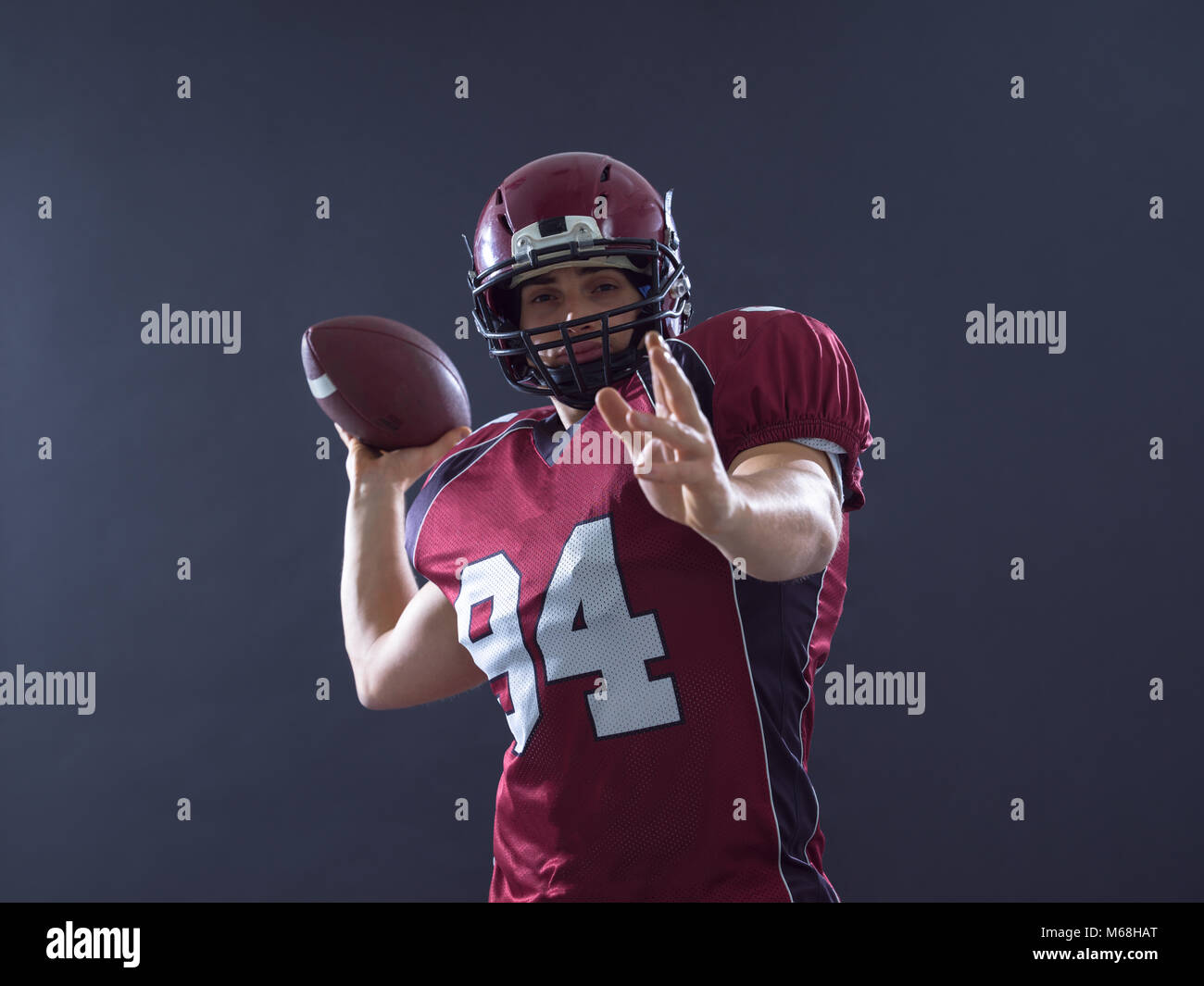 one quarterback american football player throwing ball isolated on gray ...