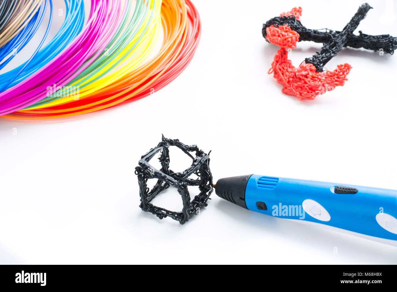 Colorful rainbow plastic filaments with for 3D pen laying on white ...