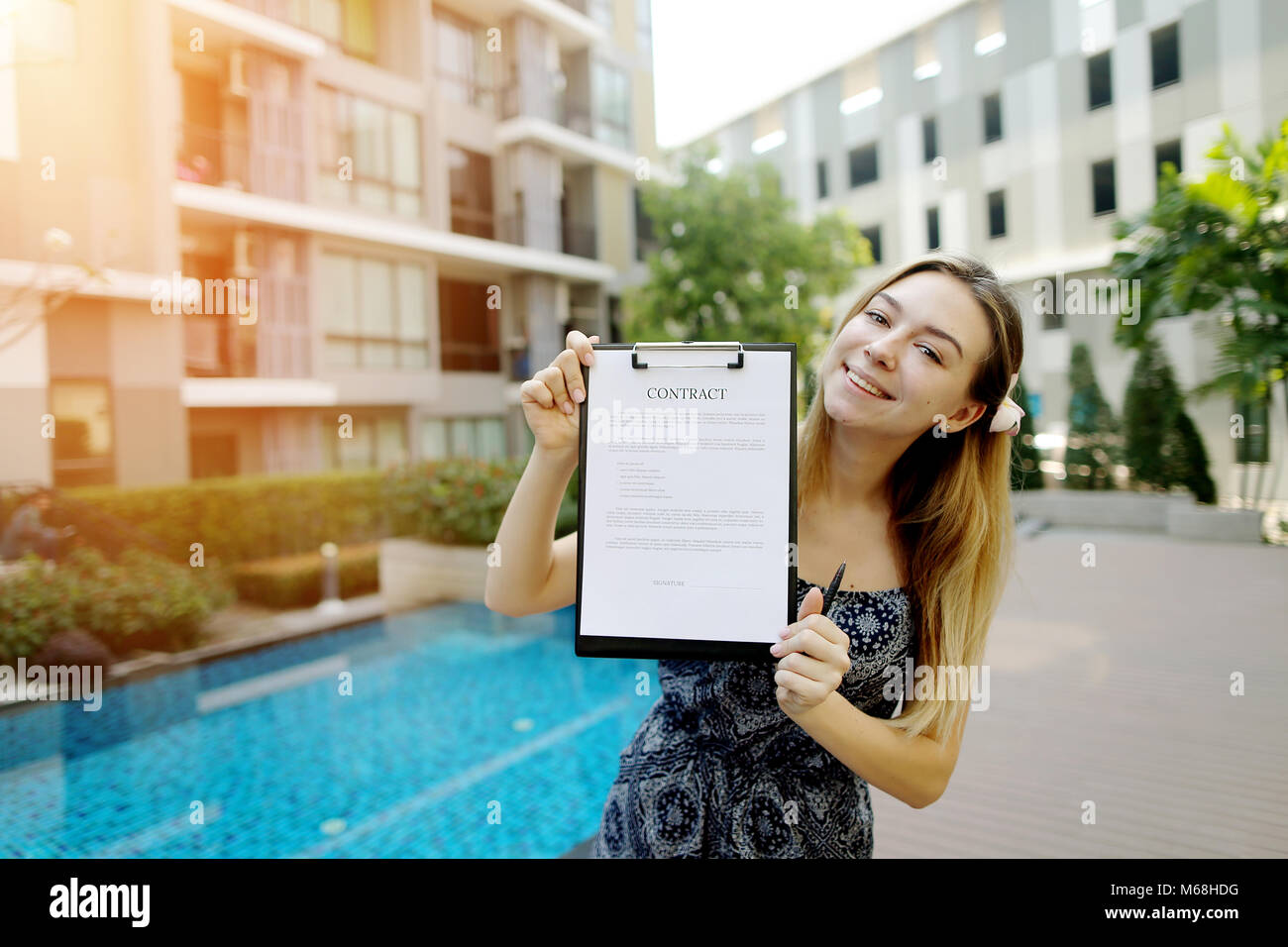 young woman offer to sign contract document on background of new ...