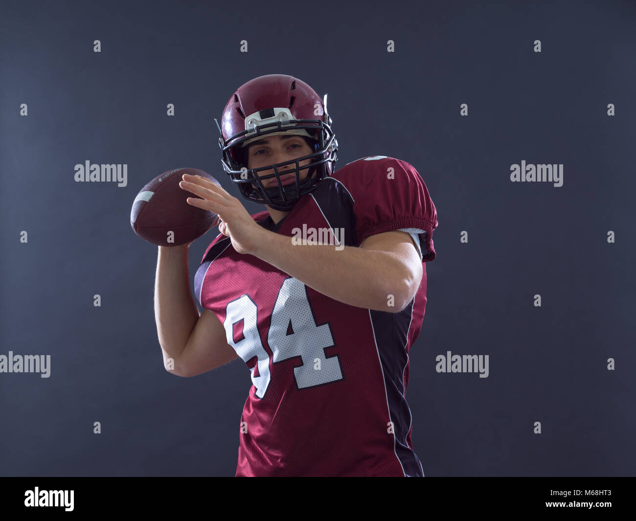 one quarterback american football player throwing ball isolated on gray ...