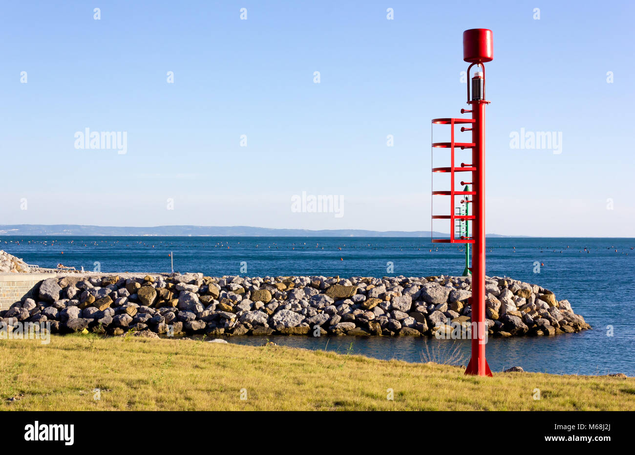 Red beacon on a rocky shore Stock Photo - Alamy