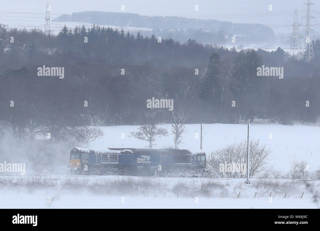 A train on the line, near Falkirk, as storm Emma, rolling in from the ...