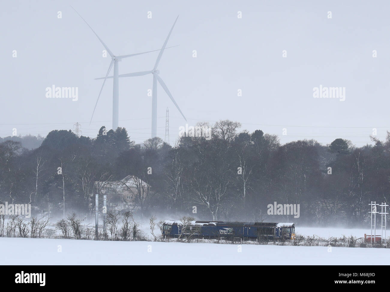 A train on the line, near Falkirk, as storm Emma, rolling in from the ...