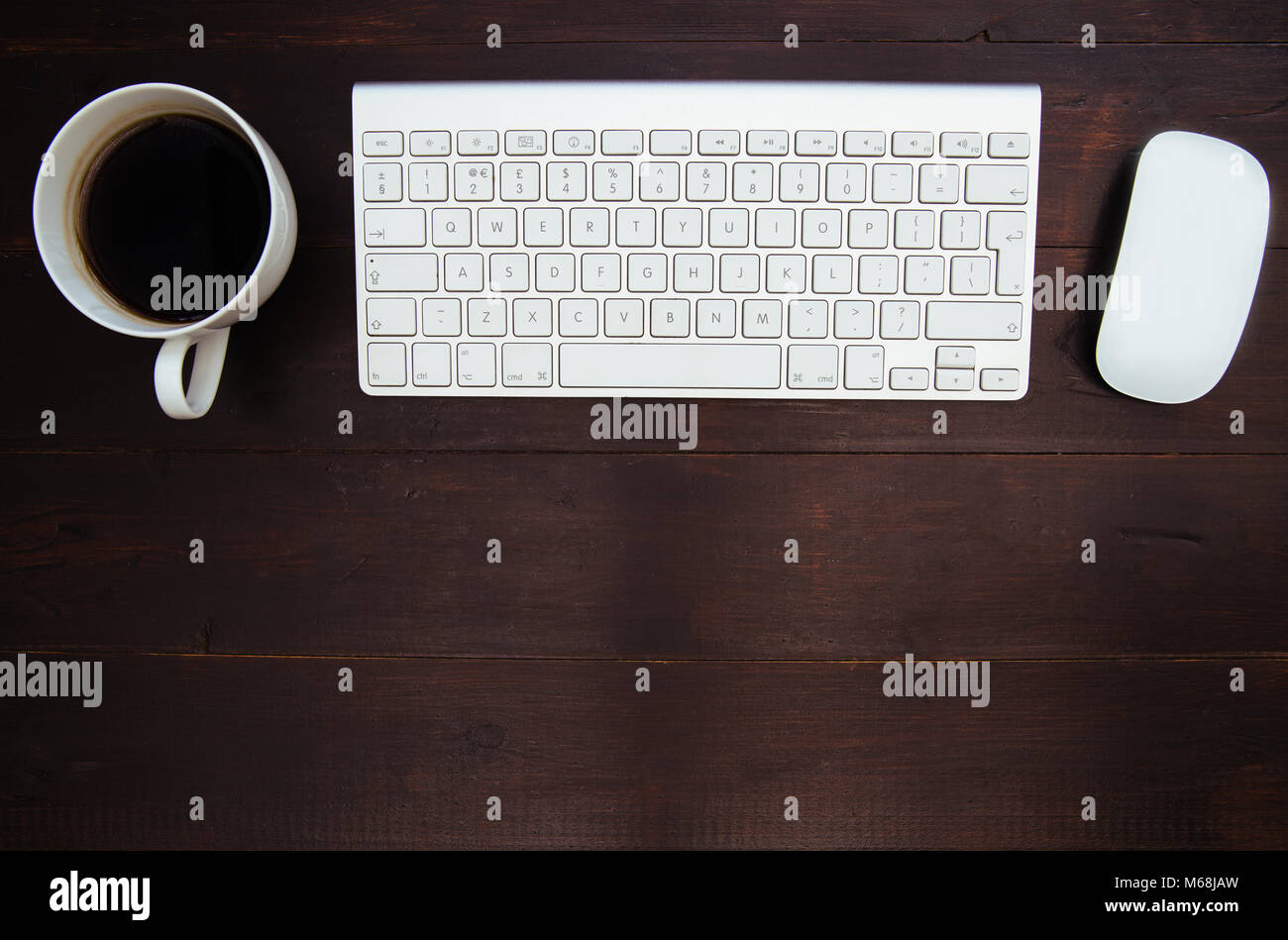 Computer keyboard and mouse overhead on dark wood background Stock ...