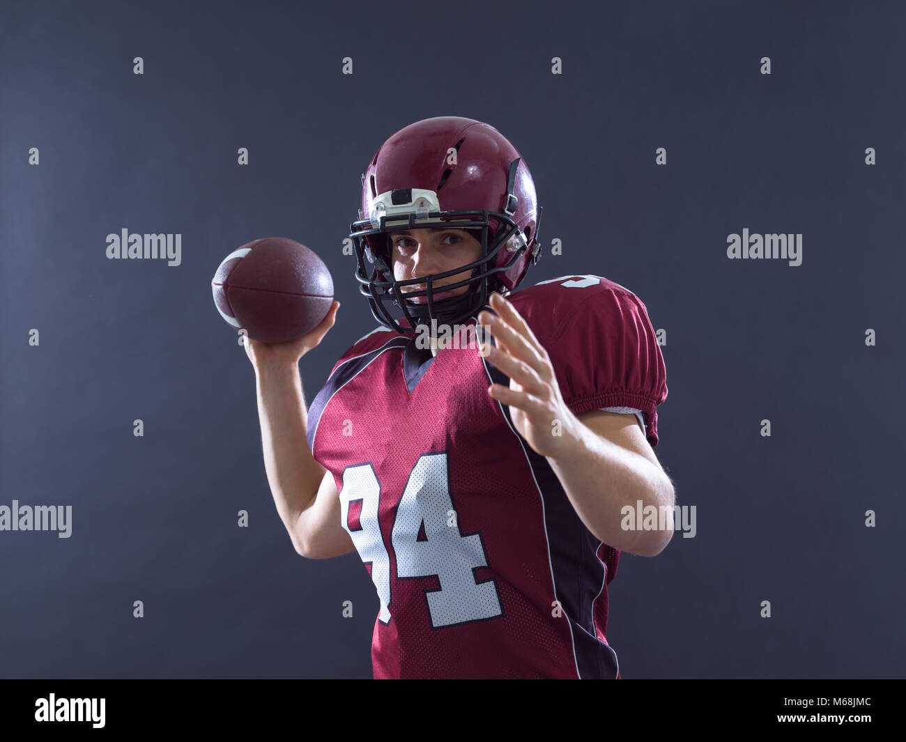 one quarterback american football player throwing ball isolated on gray ...