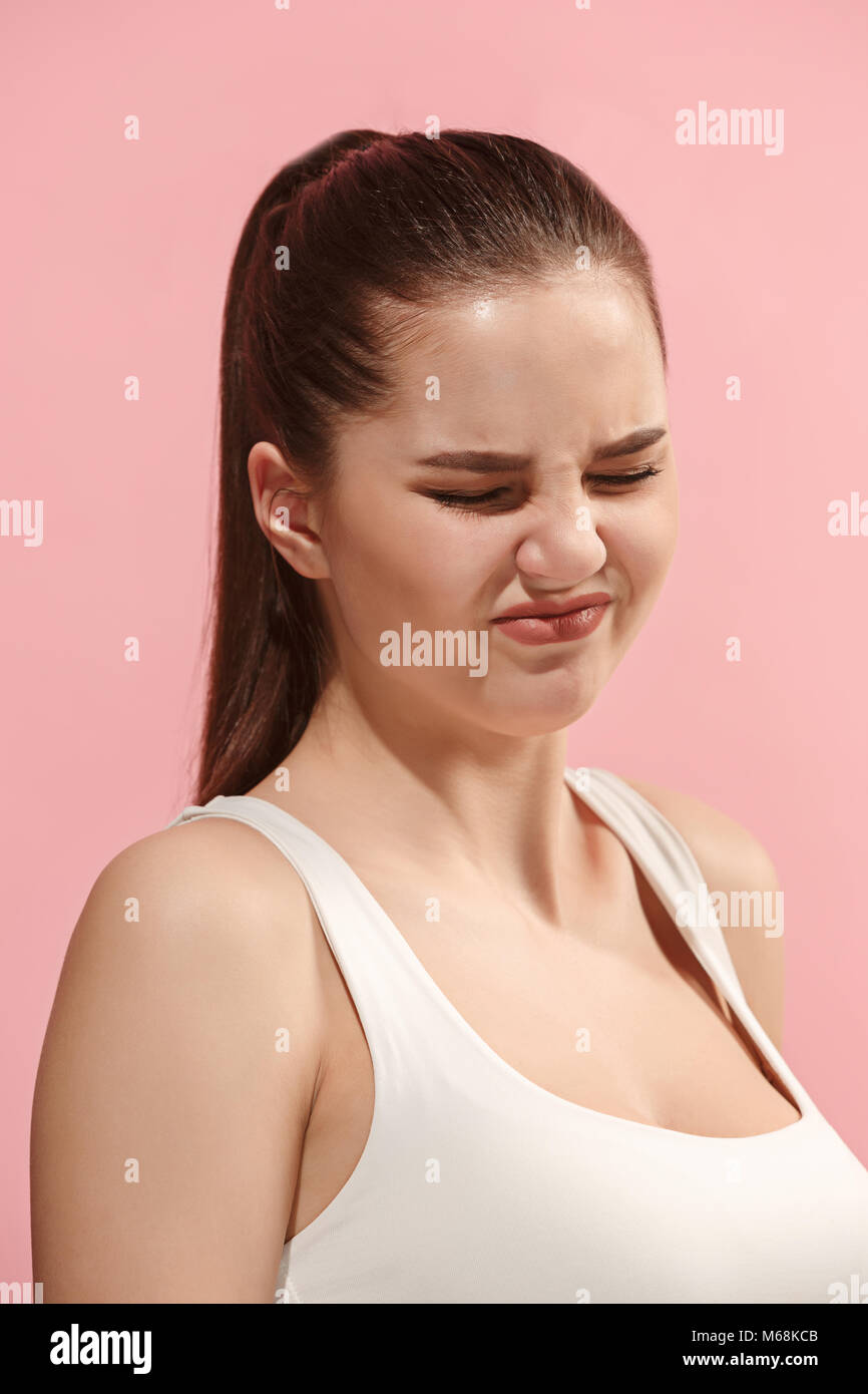 Young woman with disgusted expression repulsing something, isolated on ...