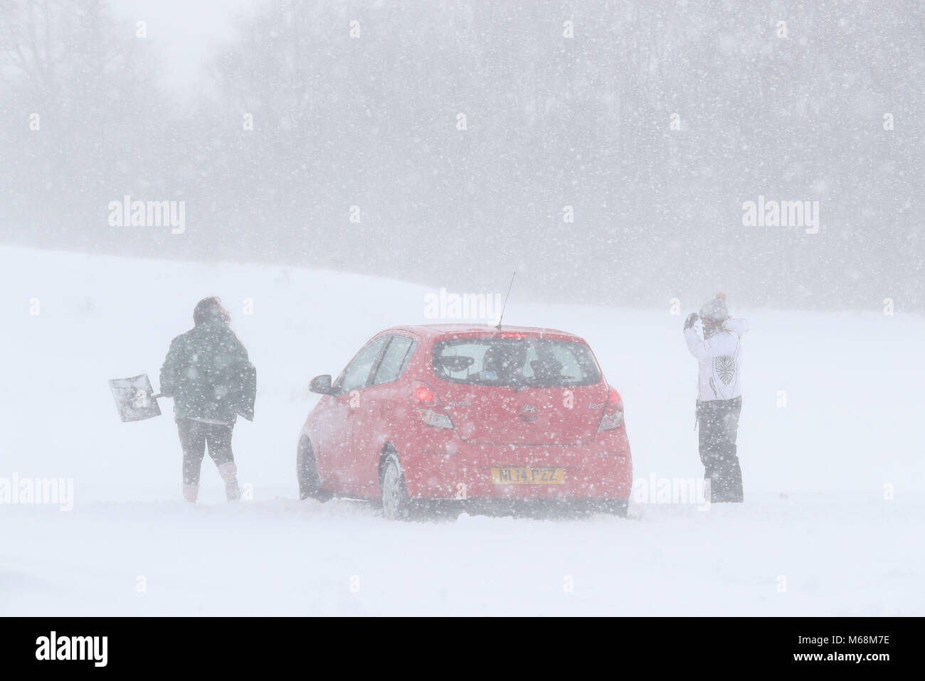 People help a stuck car in Larbert, near Falkirk, as storm Emma ...