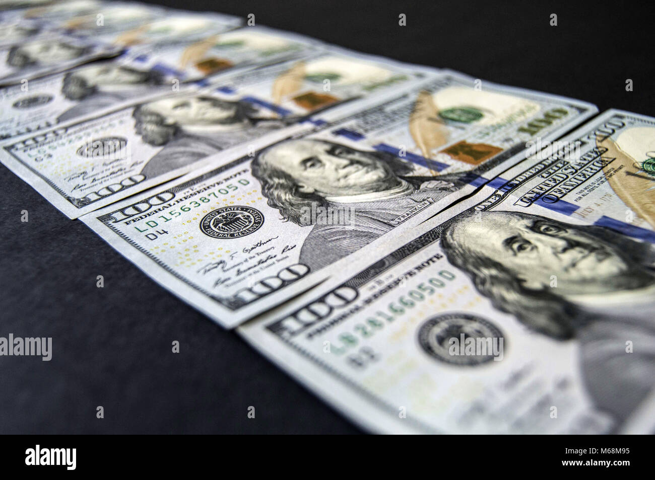 USD 100-hundred- dollars, many standing on a black background USD ...