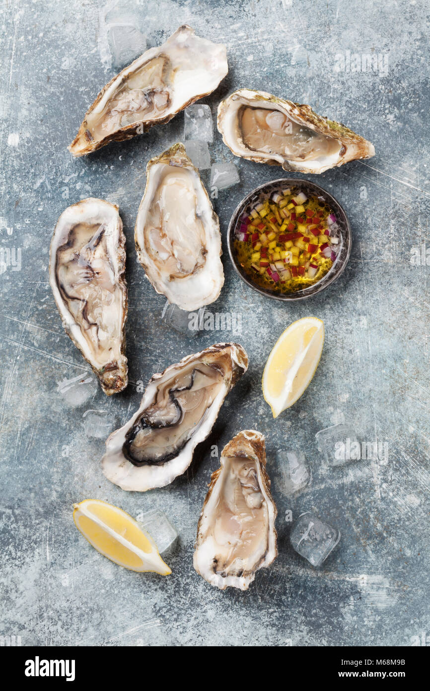 Fresh oysters on stone table. Top view Stock Photo - Alamy