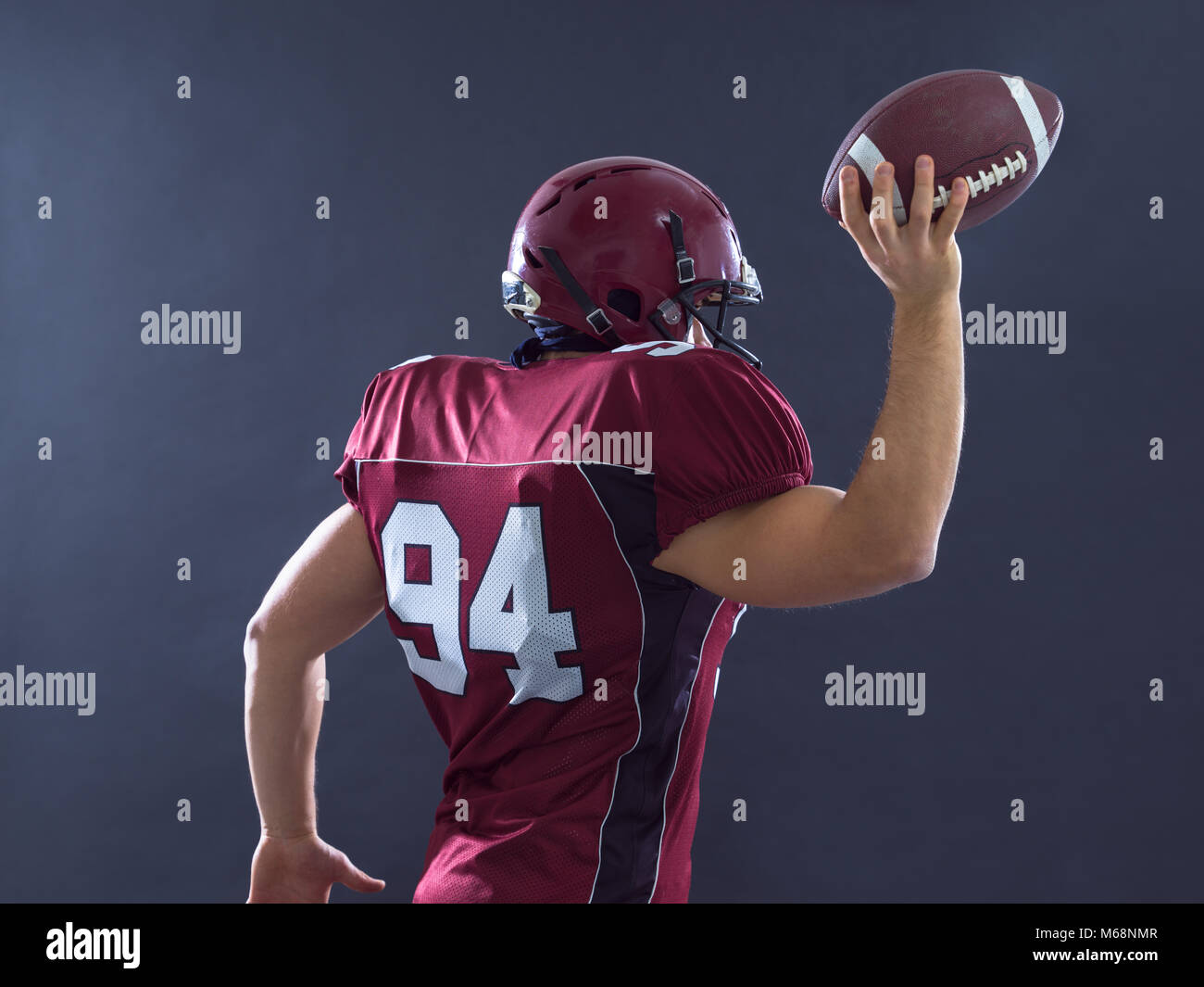 one quarterback american football player throwing ball isolated on gray ...