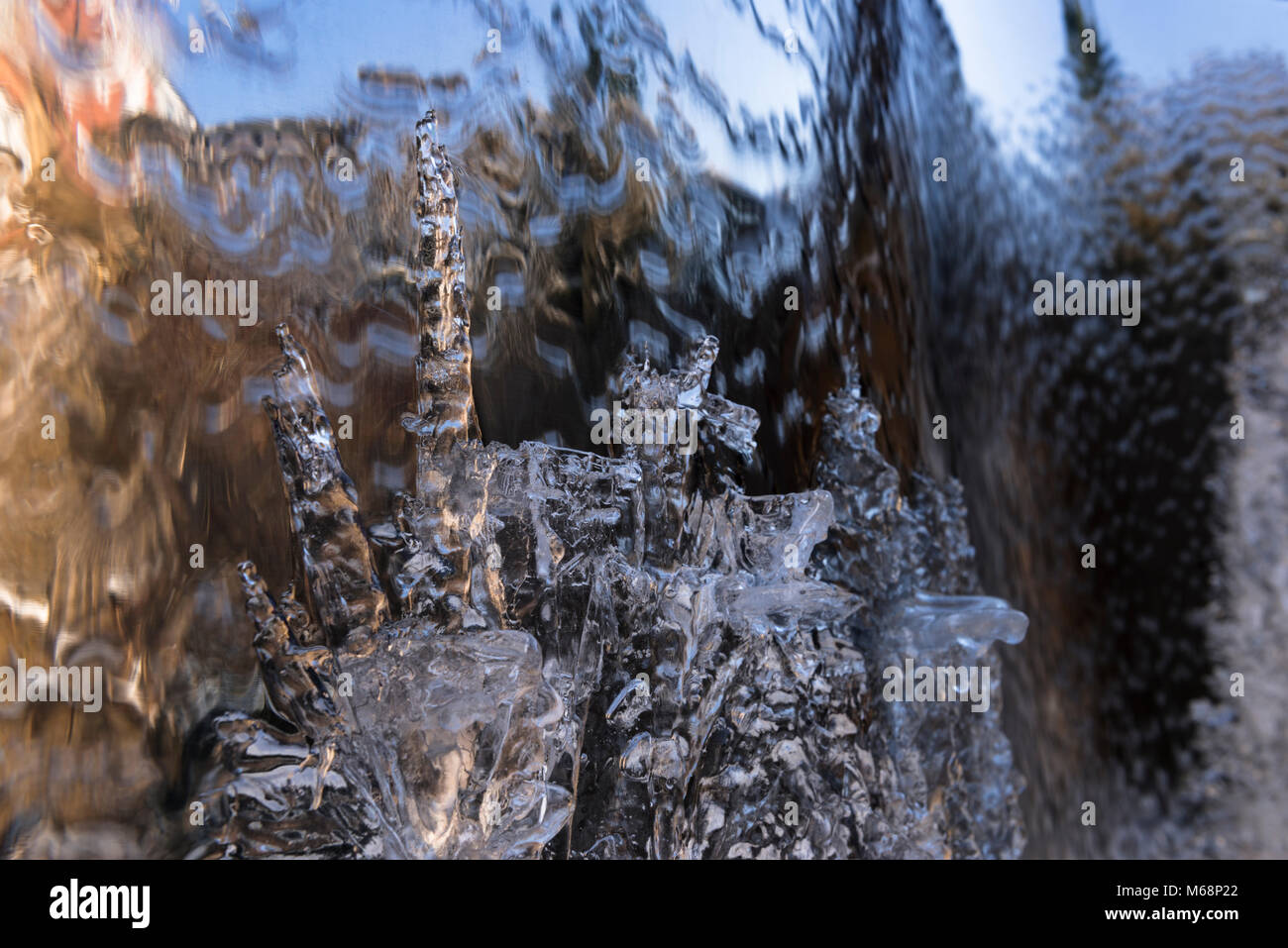 Impressionistic close up view of ice forming as a garden water feature ...