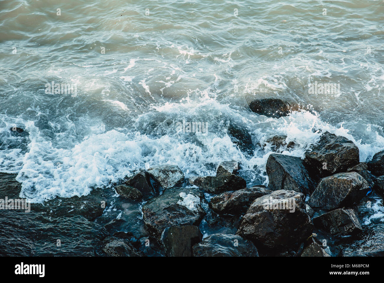 Powerful Waves impact rocky reef at sea coast Stock Photo - Alamy