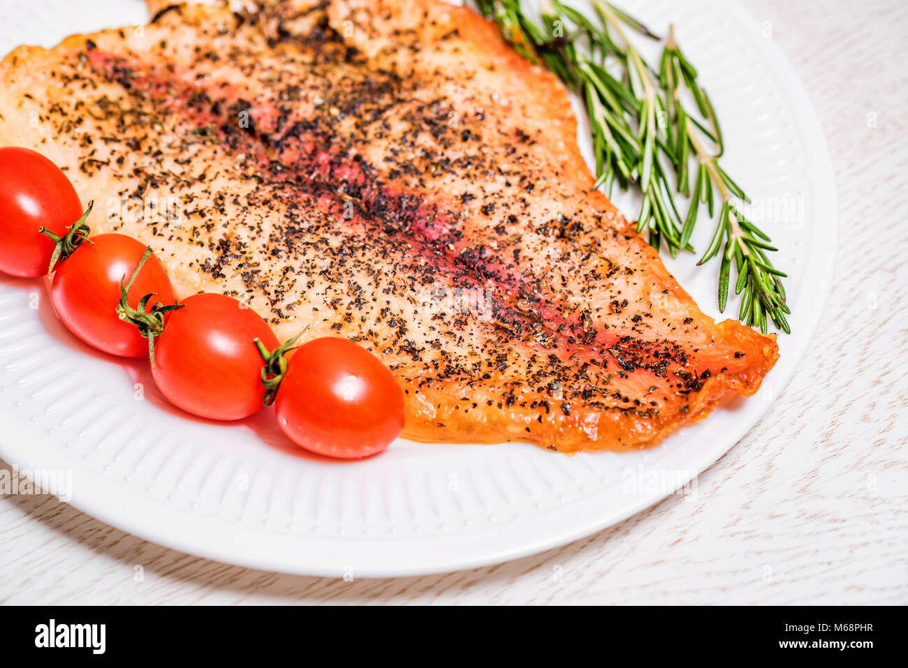 Roasted fish fillet with vegetables close Stock Photo - Alamy