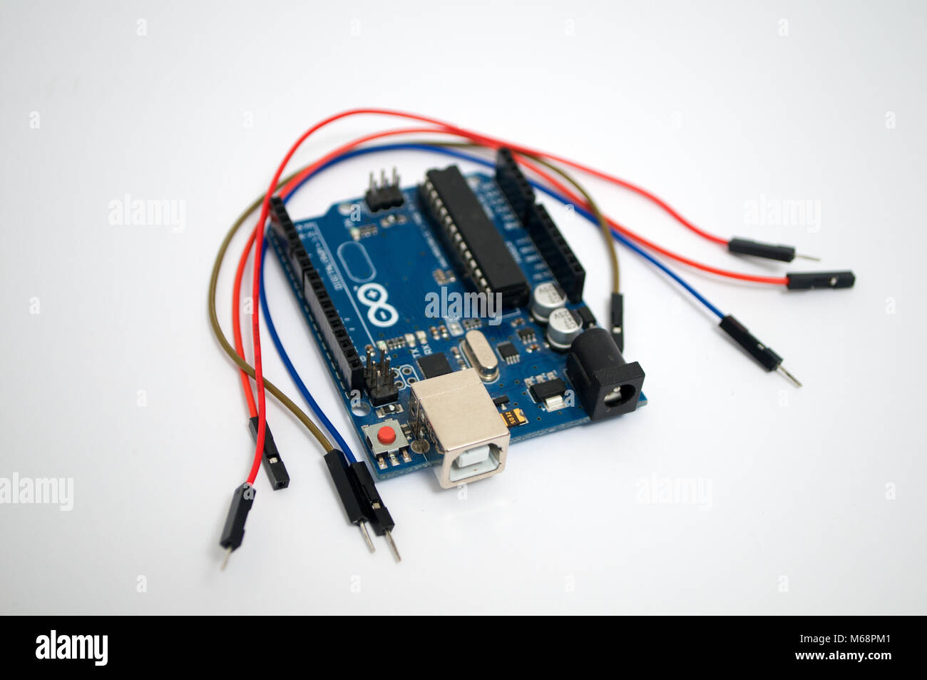 Arduino, wires and around transistors lined up on a white background ...