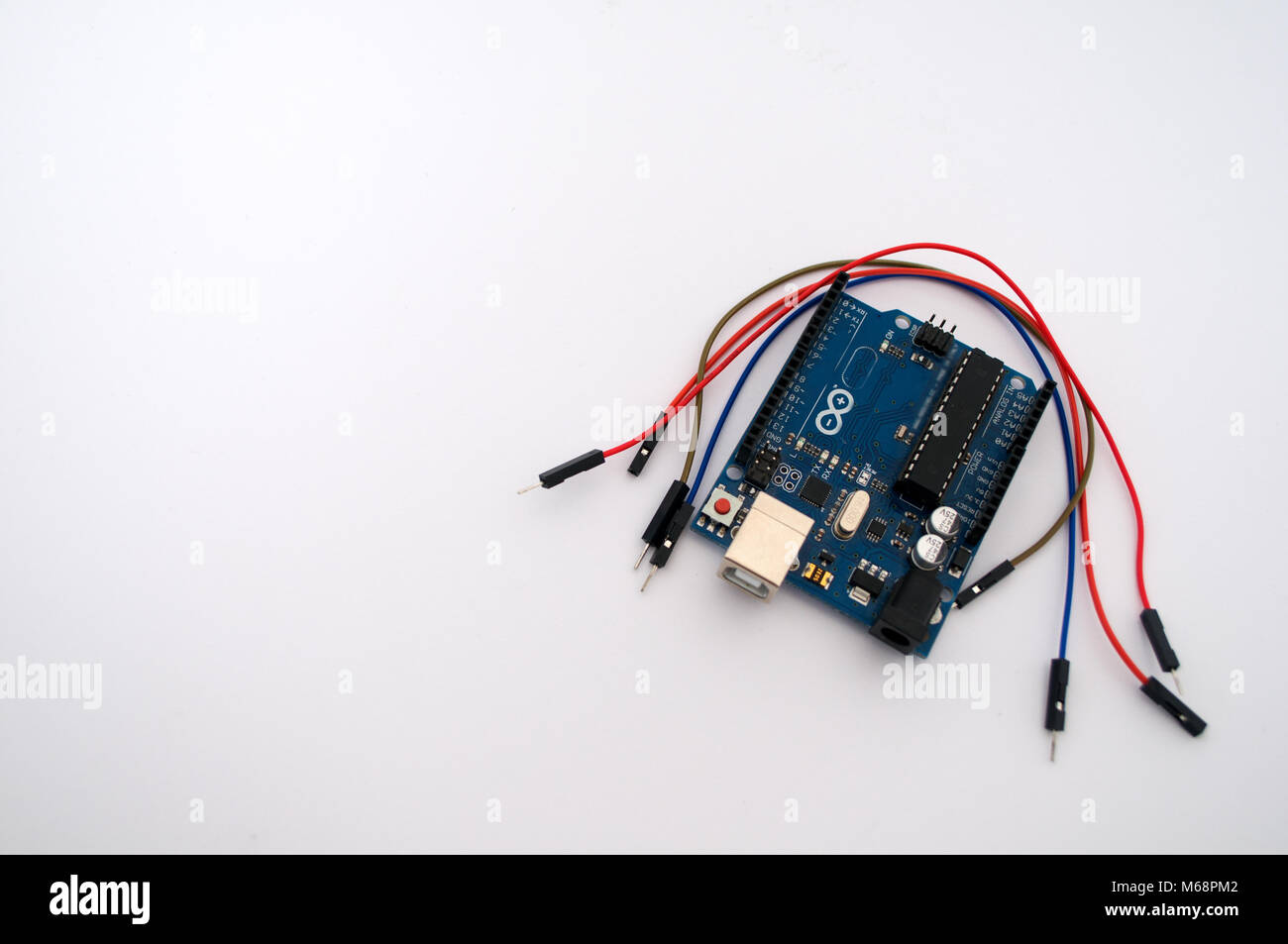 Arduino, wires and around transistors lined up on a white background ...