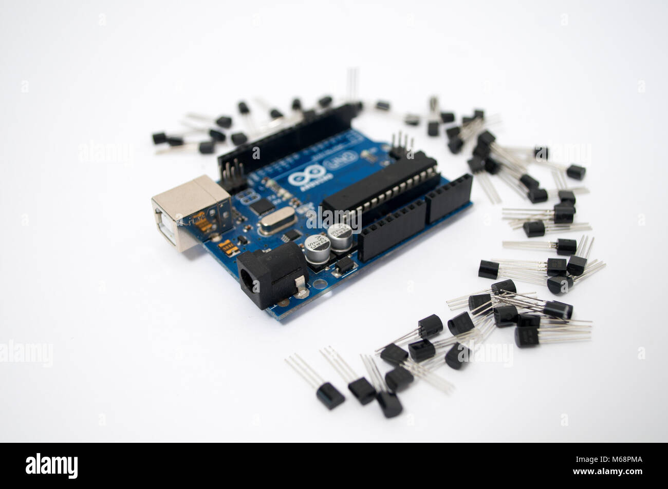 Arduino, wires and around transistors lined up on a white background ...