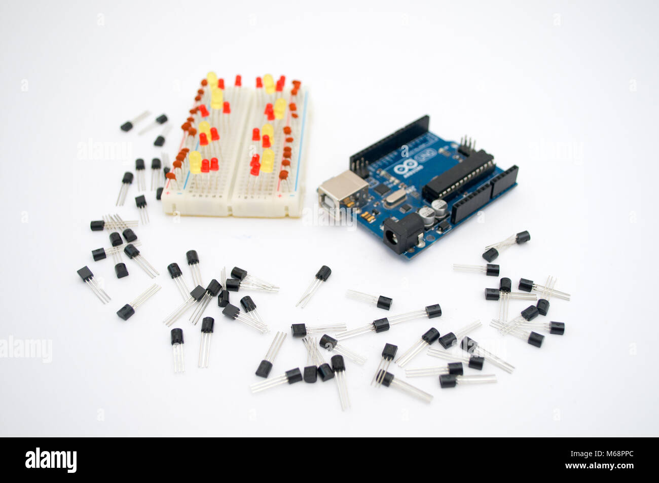Arduino, wires and around transistors lined up on a white background ...
