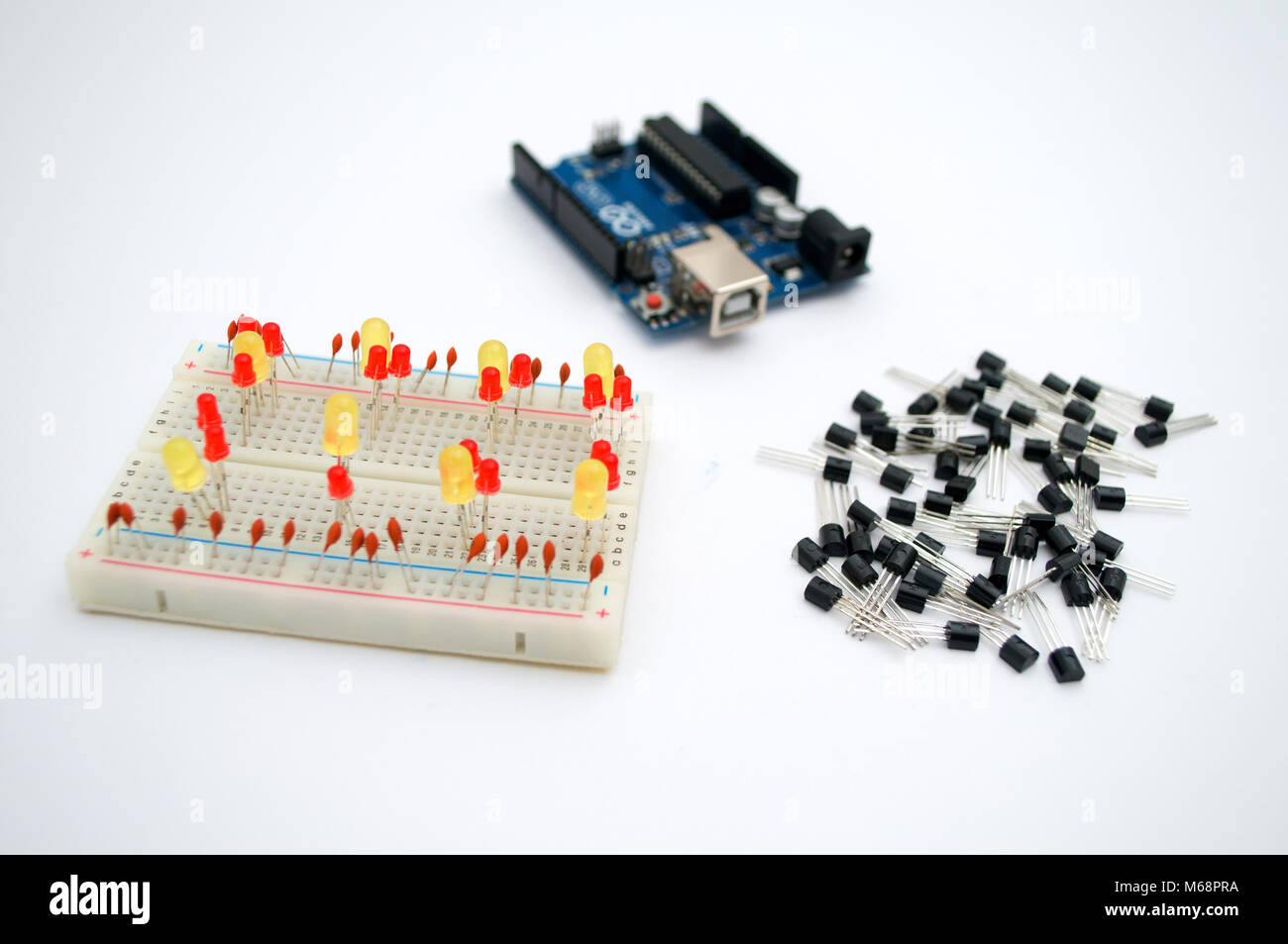 Arduino, wires and around transistors lined up on a white background ...