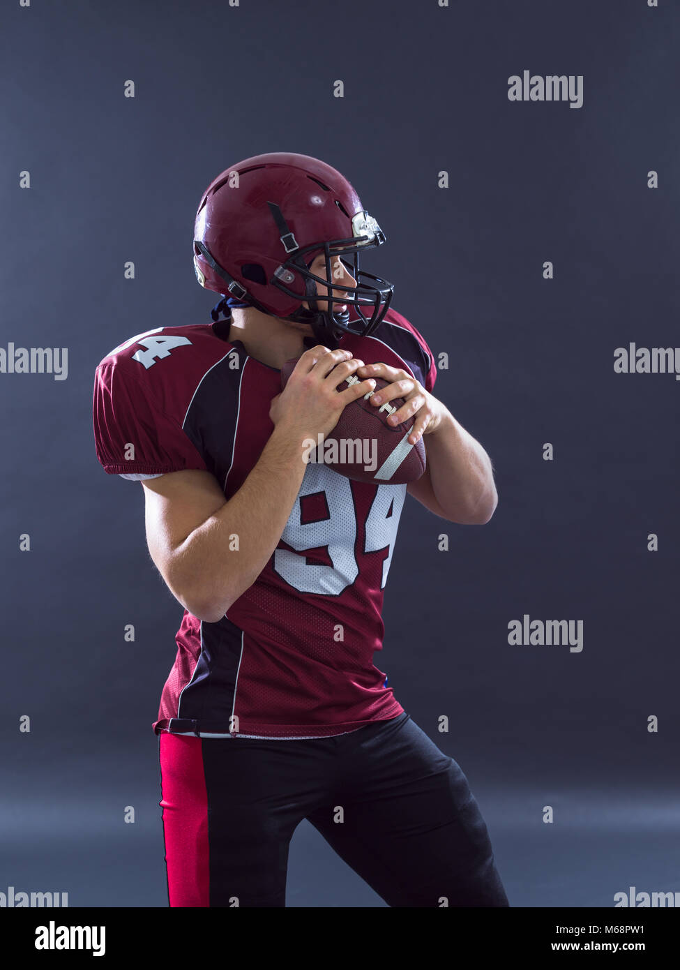 one quarterback american football player throwing ball isolated on gray ...
