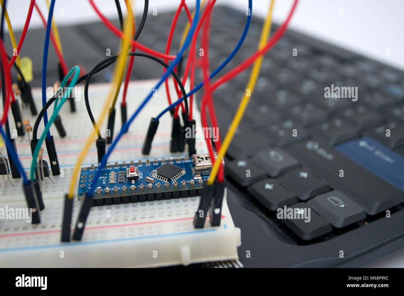Arduino, wires and around transistors lined up on a white background ...