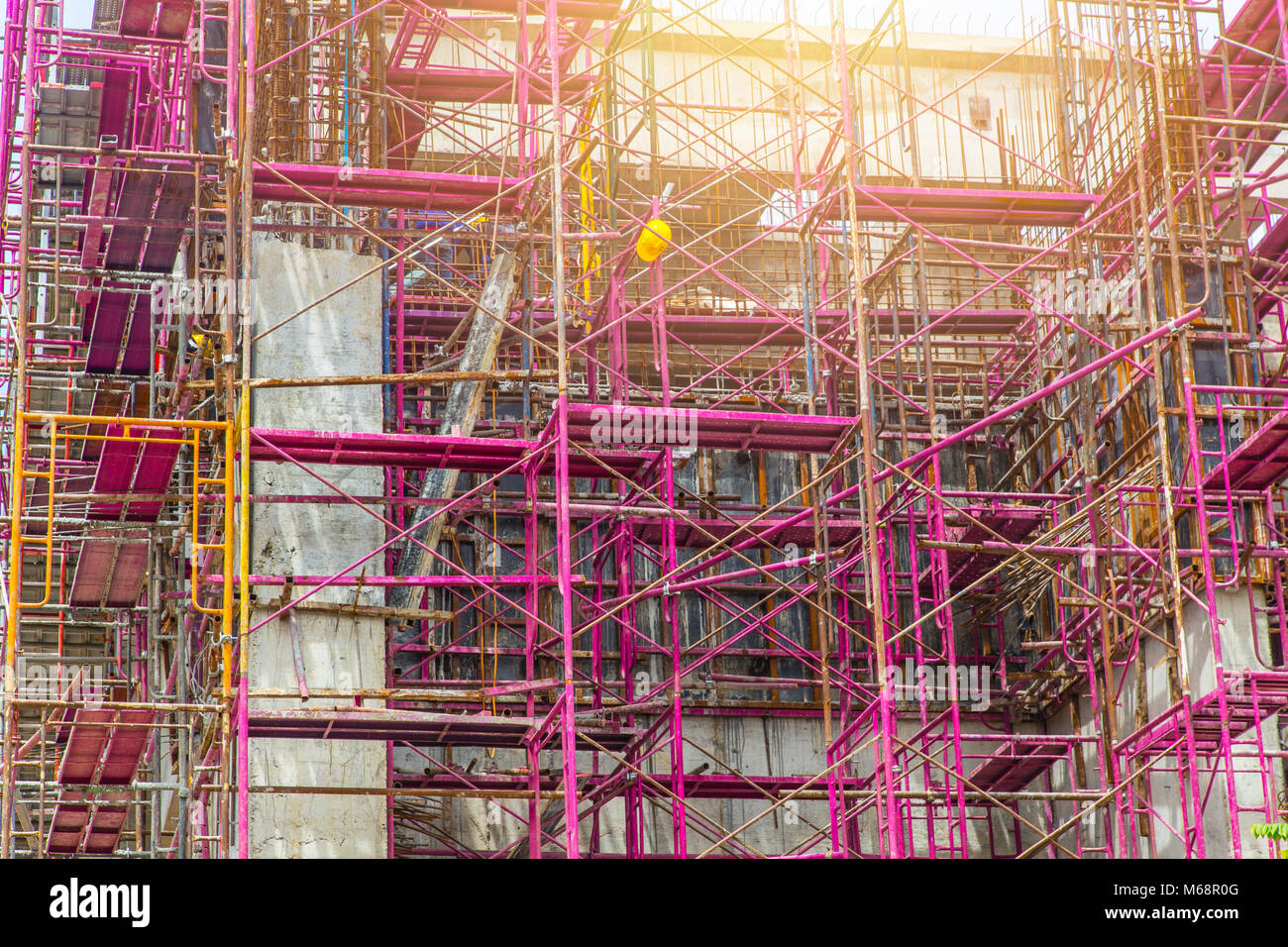 under construction building covered with scaffolding for safety ...