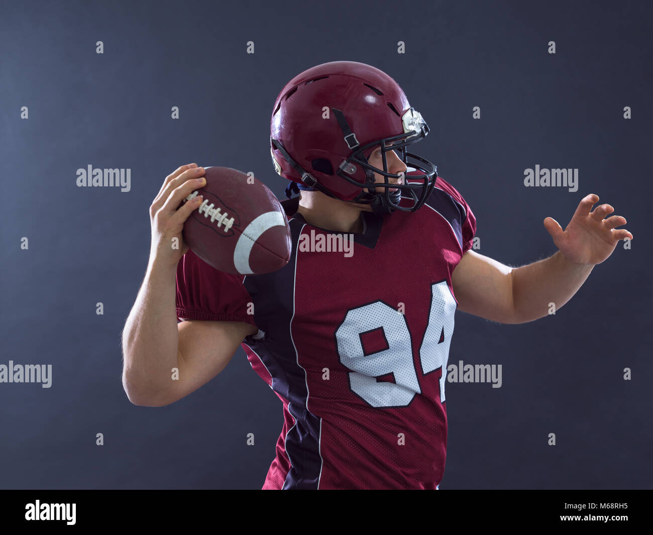one quarterback american football player throwing ball isolated on gray ...