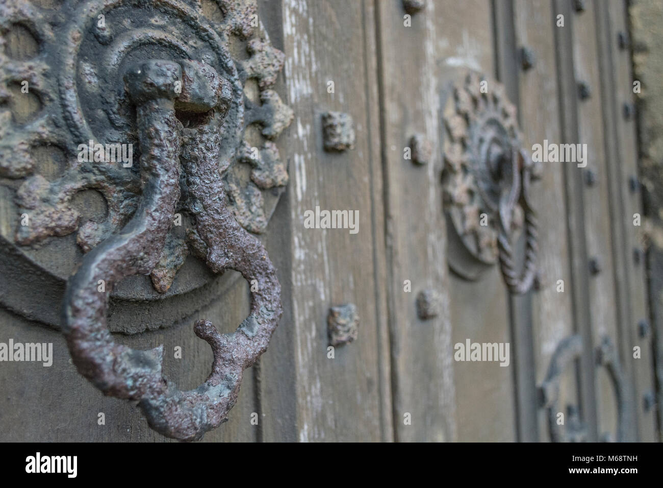 Rustic wood door lock in aged metal detail macro Stock Photo - Alamy
