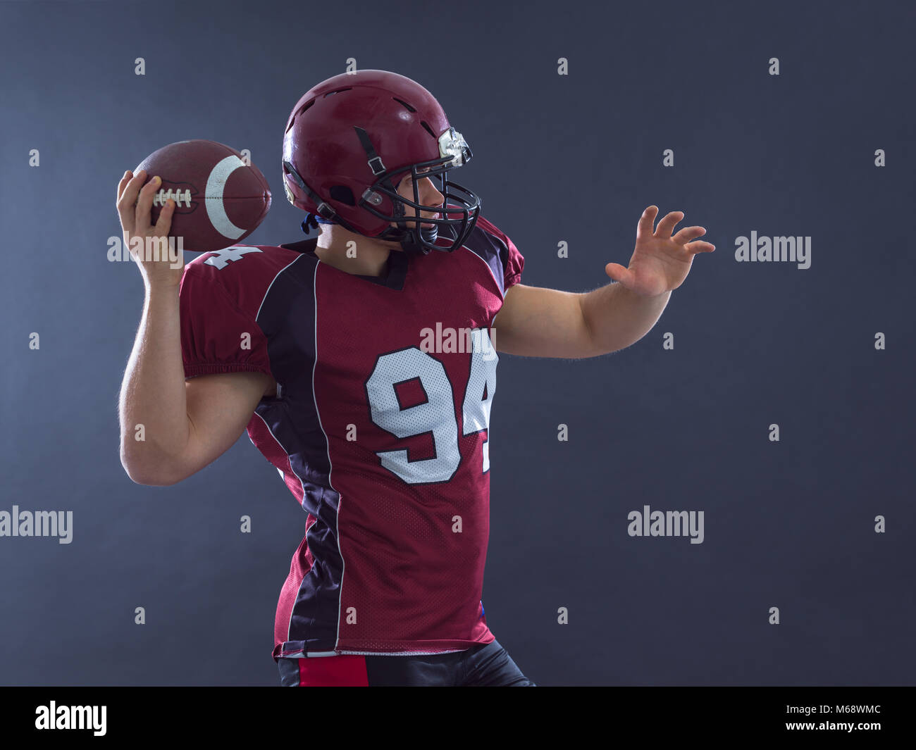 one quarterback american football player throwing ball isolated on gray ...