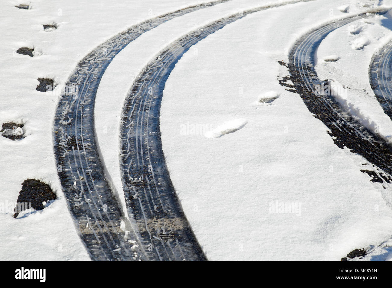 Car tyre marks in snow with foot prints Stock Photo - Alamy