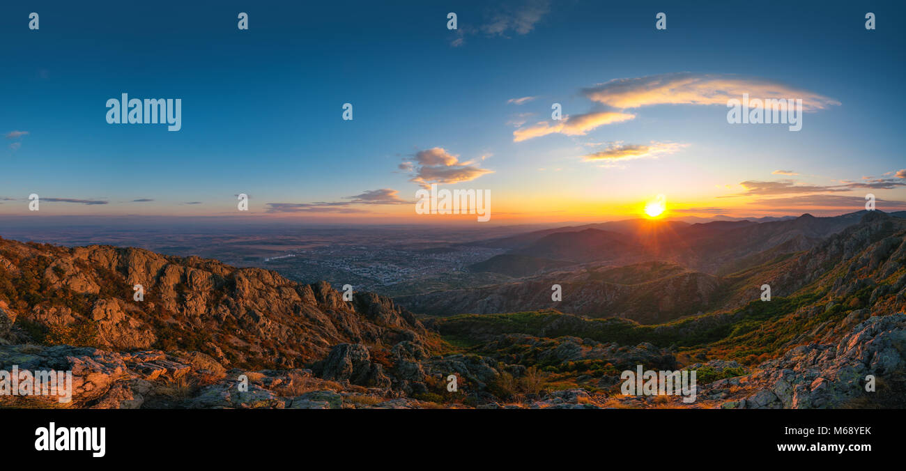 Beautiful sunset over the mountain hills and city, aerial panoramic ...