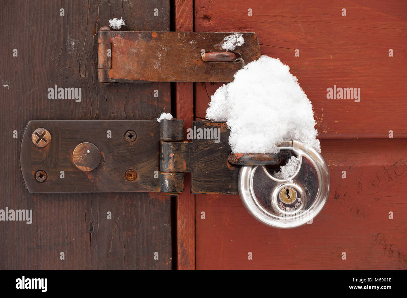 Heavy snow fall, sub zero conditions frozen padlock on garden shed door ...