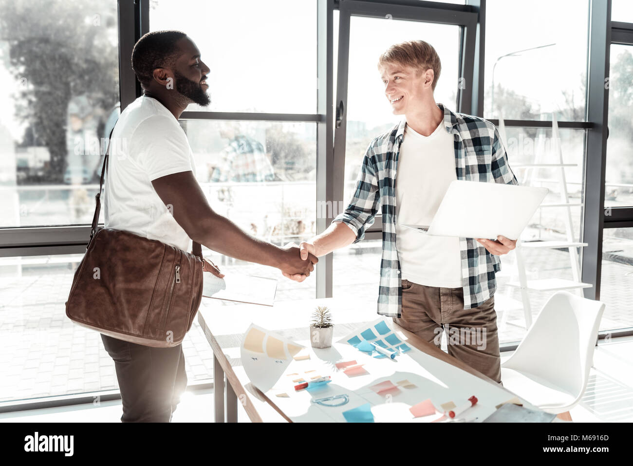 Joyful happy men greeting each other Stock Photo - Alamy