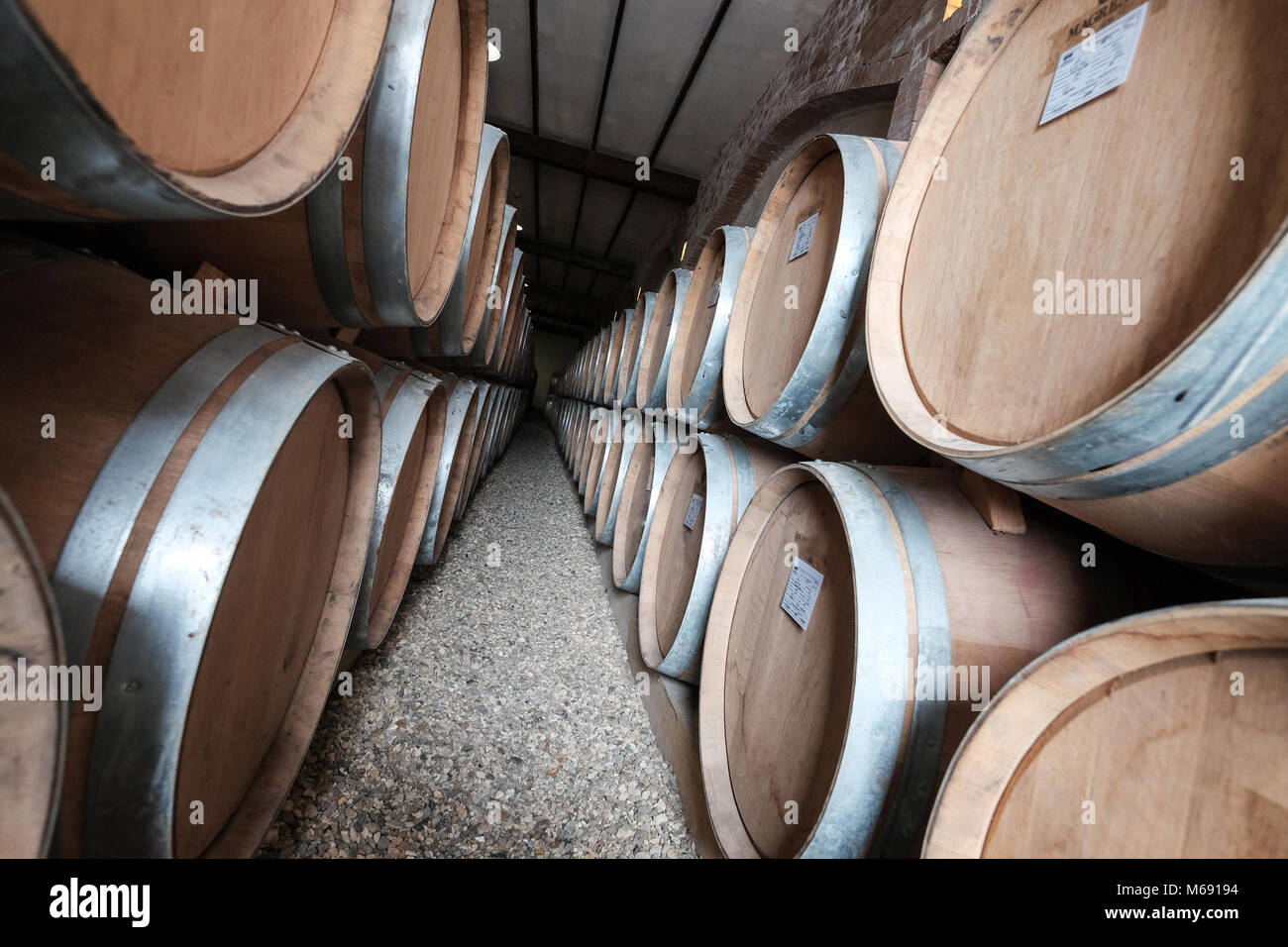 Wine barrels stacked in old winery cellar Stock Photo - Alamy