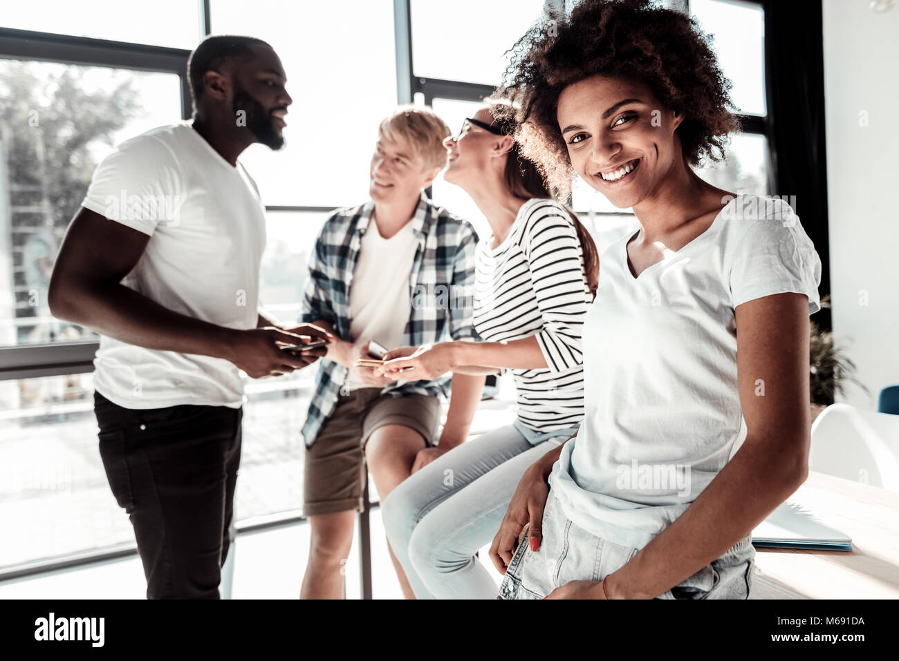 Cheerful happy woman standing together with her colleagues Stock Photo ...