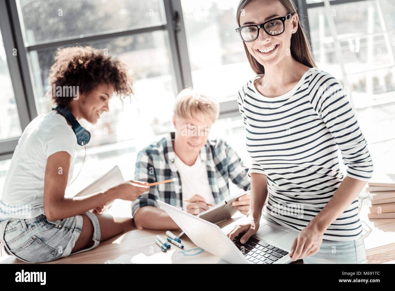 Happy smart woman holding her laptop Stock Photo - Alamy