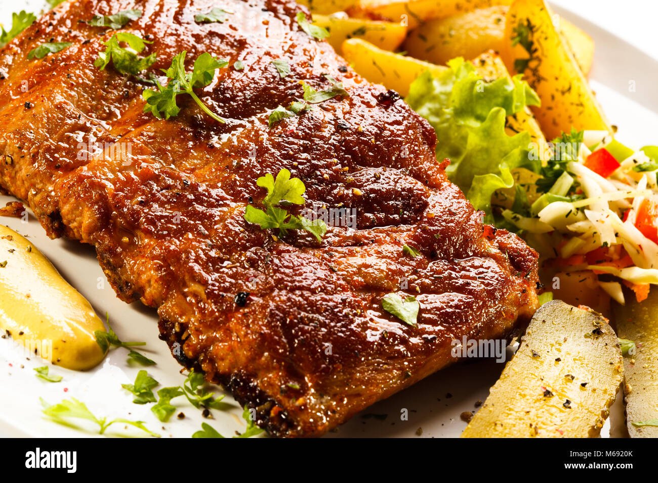 Tasty grilled ribs with vegetables Stock Photo - Alamy