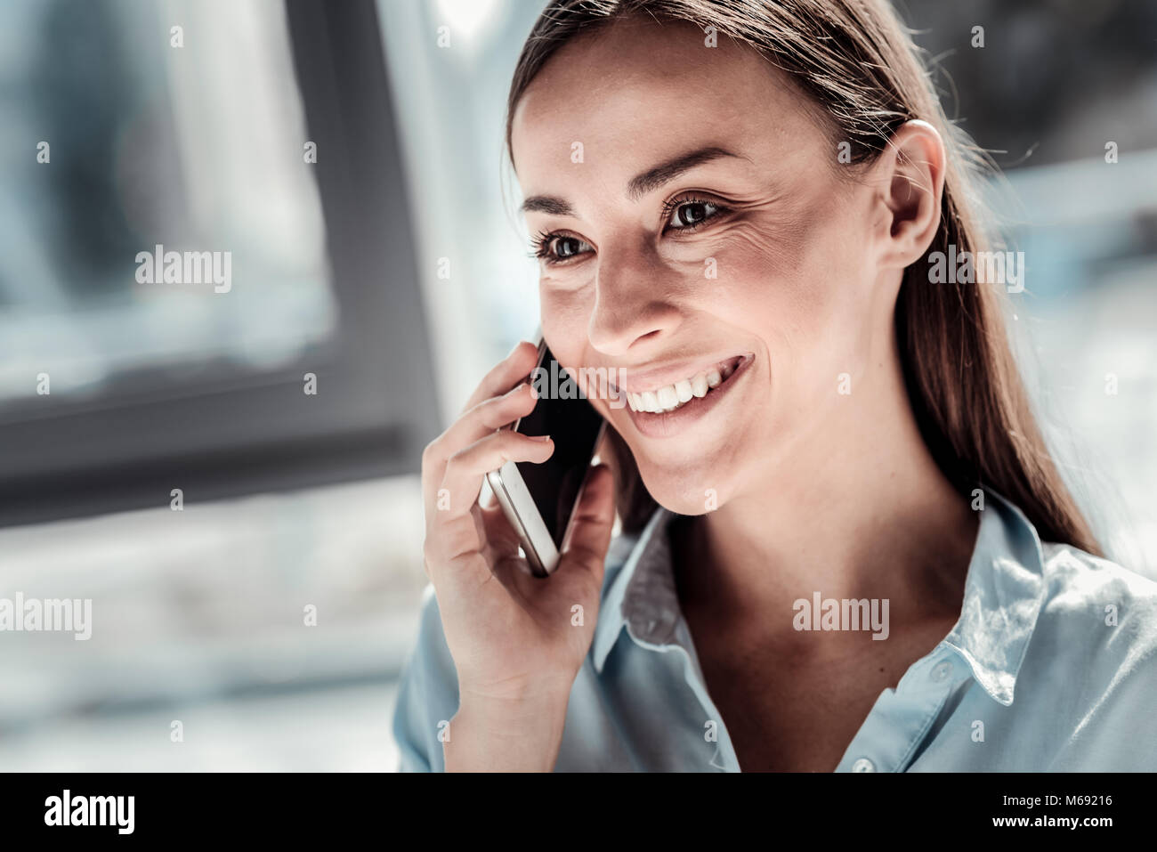 Positive young woman making a call Stock Photo - Alamy