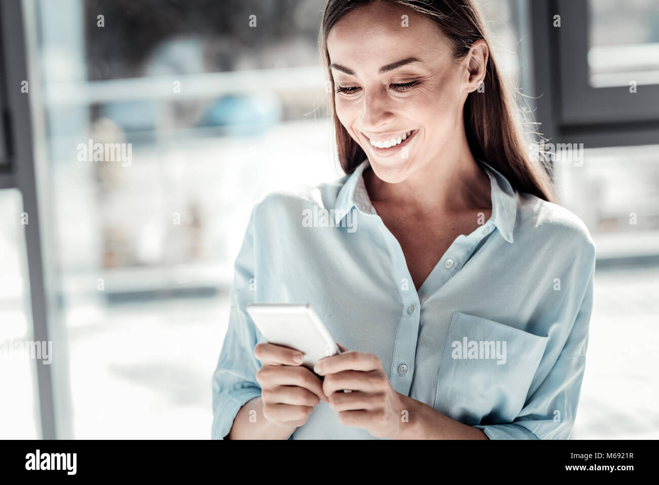 Happy smart woman using her gadget Stock Photo - Alamy