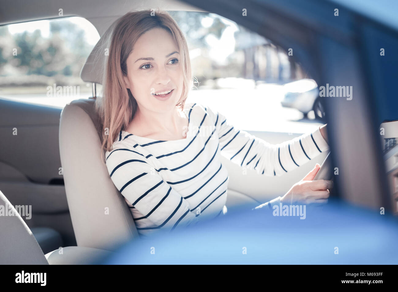 Attentive pretty woman looking on the road and driving Stock Photo - Alamy