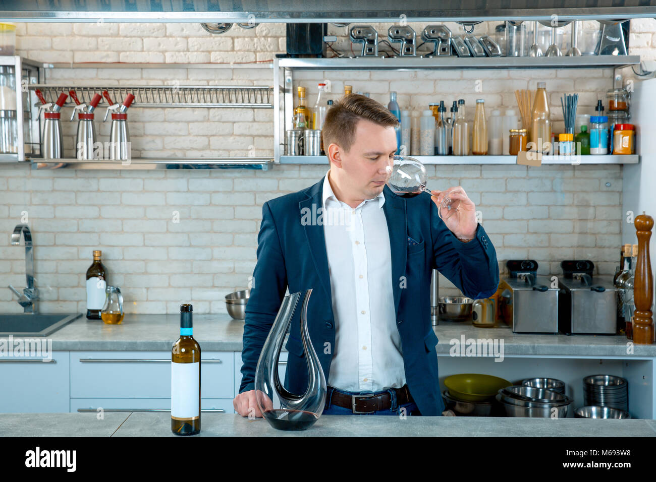 Wine expert evaluating flavor. Attractive man shaking a glass to make ...