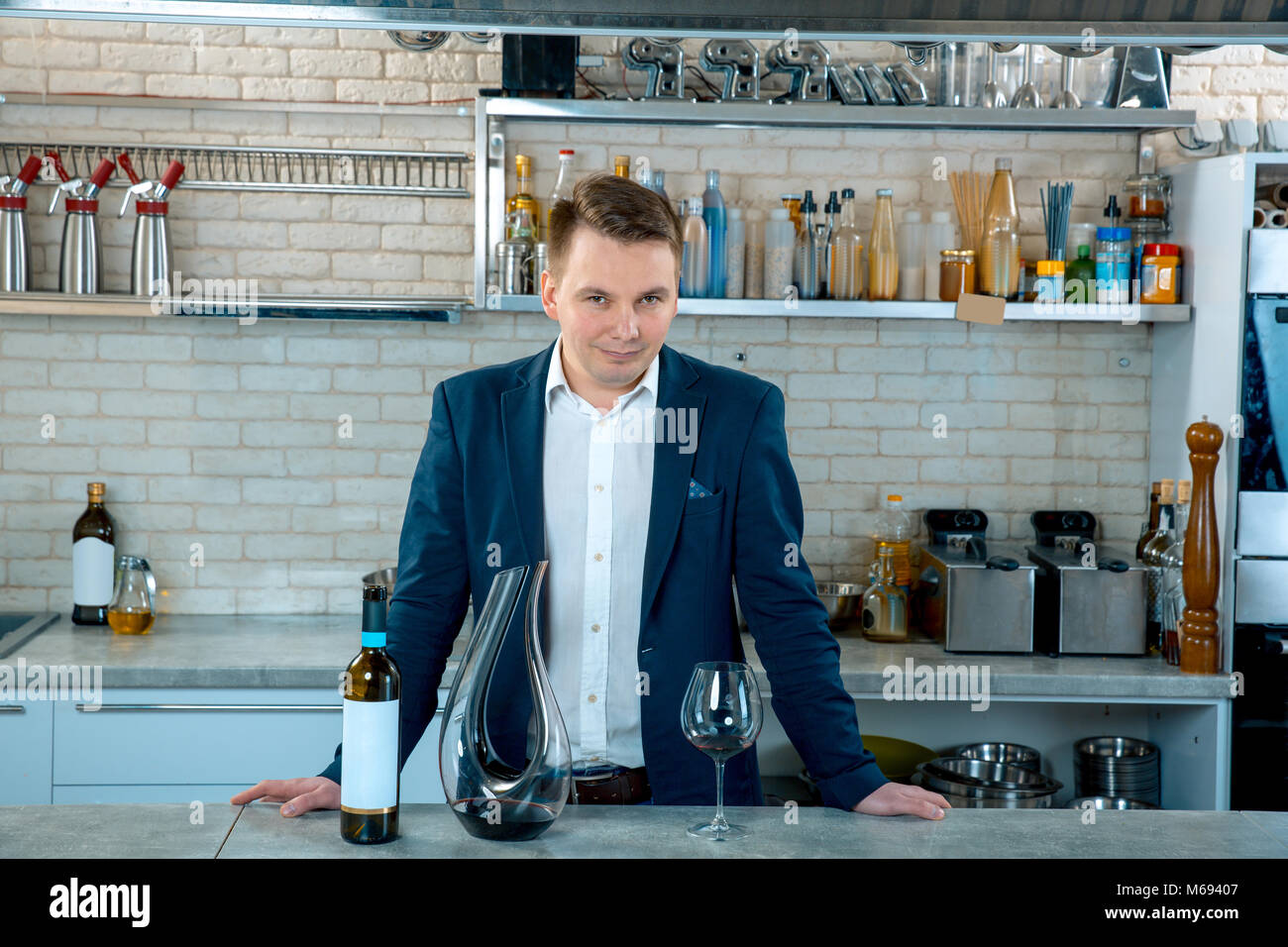 Details of perfect dinner. Confident male sommelier with wine glass and ...
