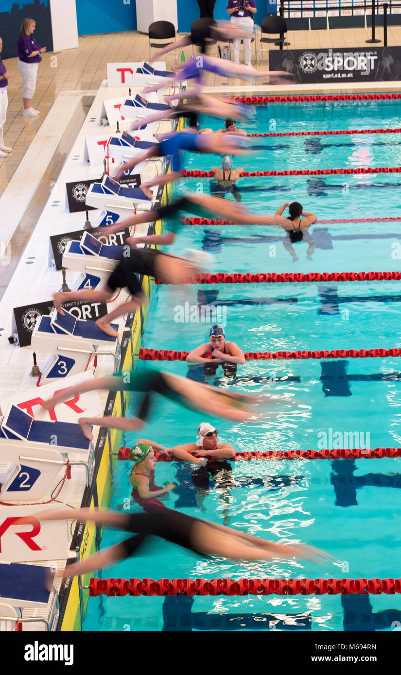 Swimmers dive in during the Women's 100m Butterfly event, day one of ...