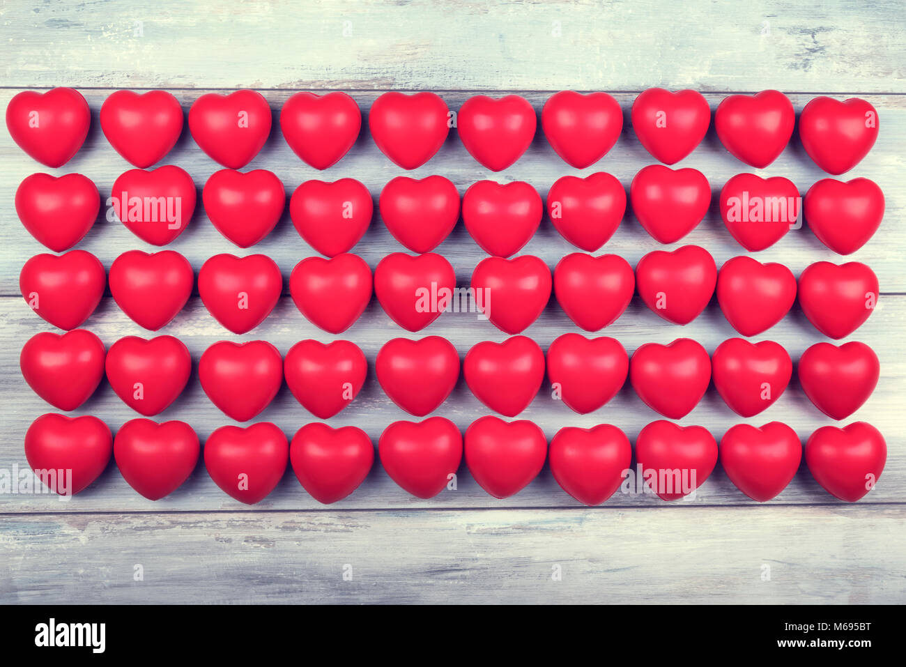 Fifty red plastic hearts in line Stock Photo - Alamy