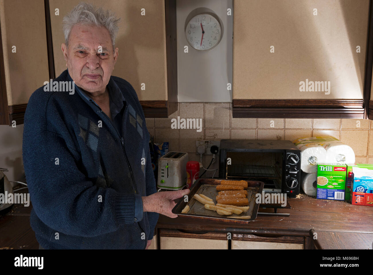 Elderly man at home uk cooking hi-res stock photography and images - Alamy