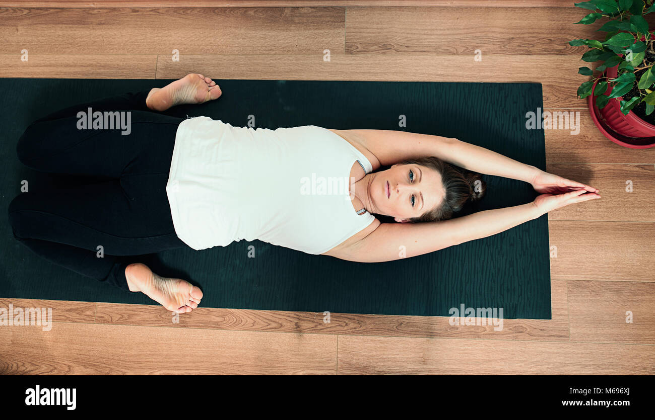 Girl in the living room is doing yoga, shooting from above Stock Photo ...