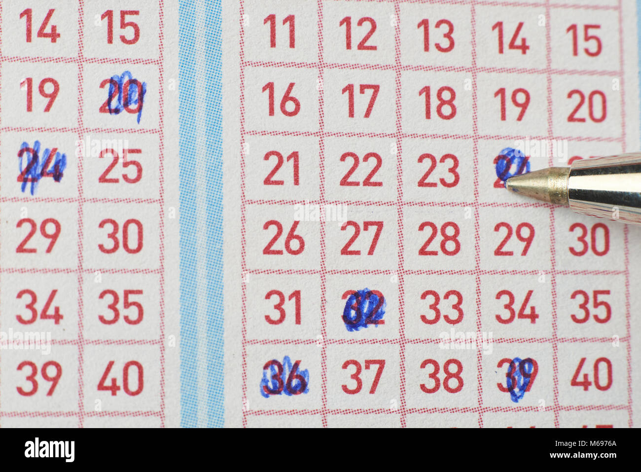 Closeup of hand marking number on lottery ticket with pen Stock Photo ...